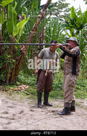 man; Indigenous, shaman; using blowgun; weapon, long rod, skill, Amazon ...