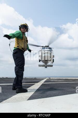 A Royal Thai Navy S-70B Seahawk helicopter hovers over the U.S. Navy ...