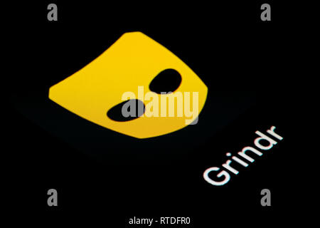 A close-up shot of the Grindr app icon, as seen on the screen of a ...