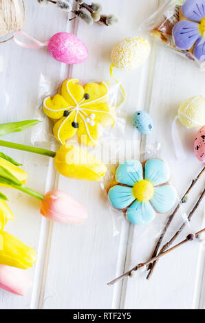 yellow tulips, ginger cookies, willow twigs, decorative eggs in a tray ...