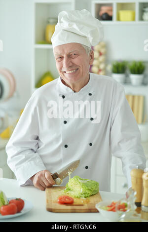 Portrait of elderly male chef cooking at kitchen Stock Photo - Alamy