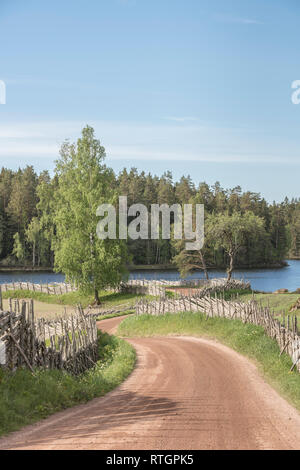 A winding road in Swedish rural landscape Stock Photo - Alamy