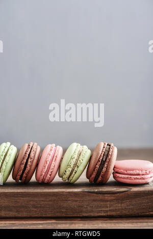 Row of different macaroons on a yellow pink background. Creative layout ...