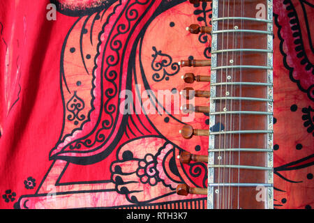 old sitar on red background - ancient indian instrument Stock Photo - Alamy