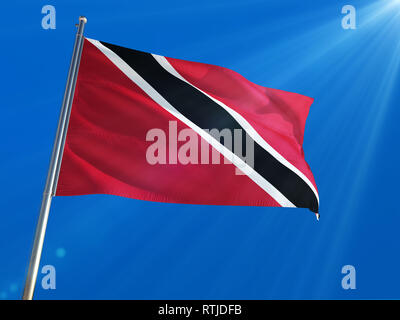 National flag of Trinidad and Tobago on a flagpole in front of blue sky ...