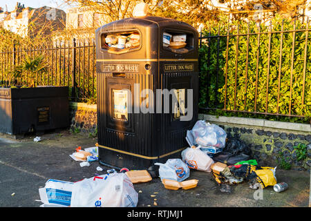 Black plastic waste containers marked with retroreflective tape ...