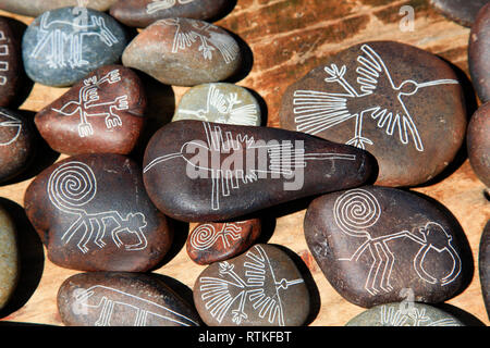 Souvenirs of Nazca lines carved into small rounded stones Stock Photo ...