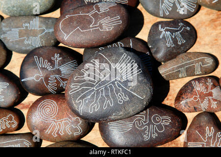 Souvenirs of Nazca lines carved into small rounded stones Stock Photo ...