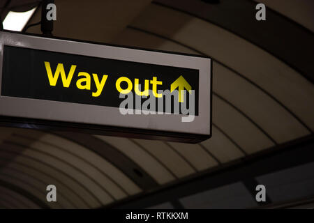 Way out sign at Brixton tube station, with train waiting at platform ...