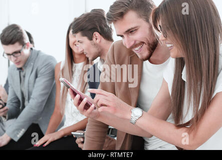 Young people of different nationalities are using gadgets, talking and ...