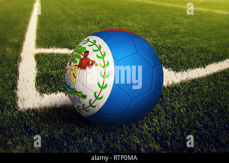Belize flag on ball at corner kick position, soccer field background ...