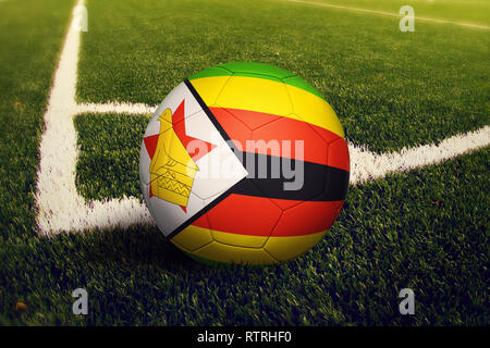 Zimbabwe flag on ball at corner kick position, soccer field background ...
