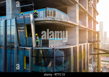 Workers are Installing the Precast Glass Panel on The Construction Site ...