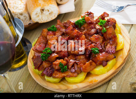 Delicious spanish dish Morro de cerdo, braised pig snout served in clay ...