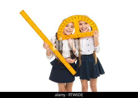Geometry lesson is much fun. Little girls holding protractor and ruler ...