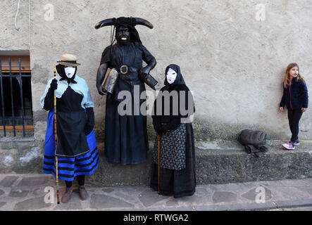 Revelers wearing traditional bull-head masks take part in the ...