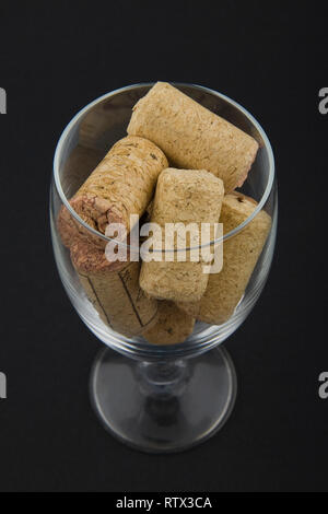wineglass filled with corks on dark background Stock Photo - Alamy