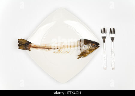 eaten fish with head and tail - symbol of misery Stock Photo - Alamy