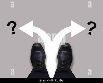 Businessman With Left Or Right Arrows And Question Mark Stock Photo - Alamy