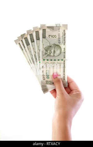 Hand Giving Indian 500 and 2000 Rupee Bank Notes over wheat background ...