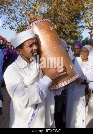 A religious Jewish man carrying a Torah scroll from the Holy Ark to the ...