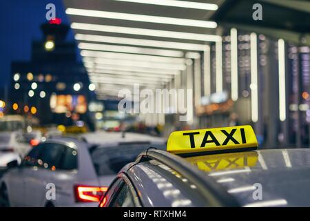 Airport Taxi sign illuminated at night Stock Photo - Alamy