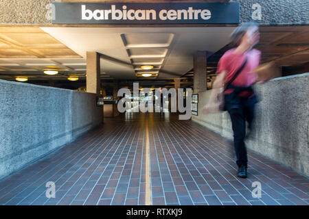 Walking through the interior walkways of the Barbican centre Stock ...