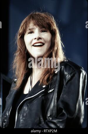 Pop singer Tiffany is shown performing on stage during a "live" concert ...