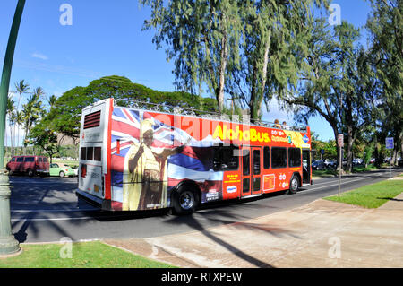 Colorful red double-decker bus moves quickly through motion blur effect ...