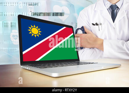 Namibian Doctor standing with stethoscope on Namibia flag background ...