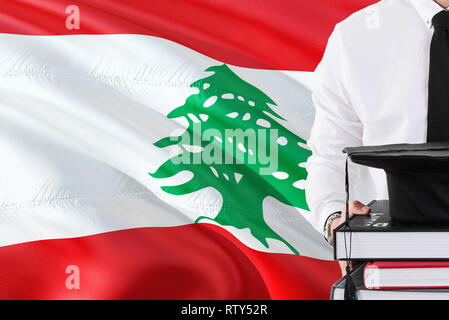 Young teenager boy holding Lebanon passport looking positive and happy ...