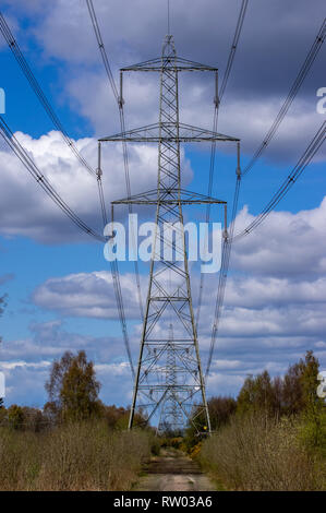 Large tall steel power pylons in rather flat landscape of Saudi Arabia ...