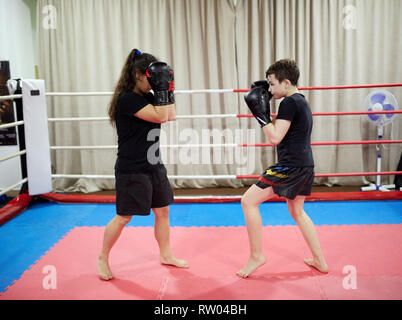 Boy and girl kickbox fighters sparring in the ring Stock Photo - Alamy