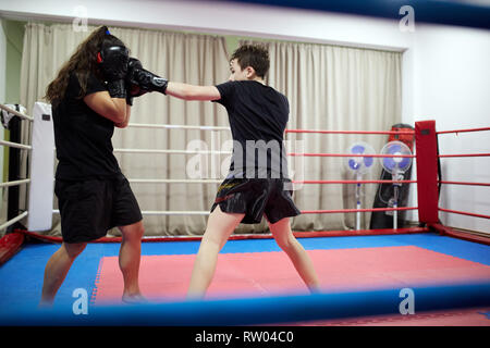 Boy and girl kickbox fighters sparring in the ring Stock Photo - Alamy