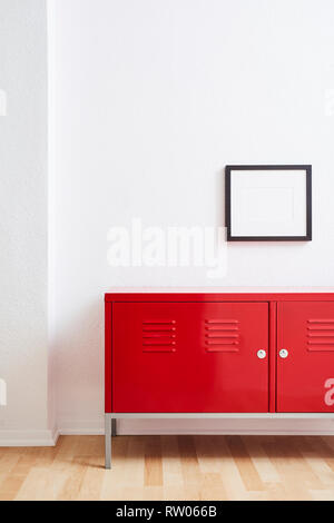 Cabinet and pictures on the wall in light room Stock Photo - Alamy