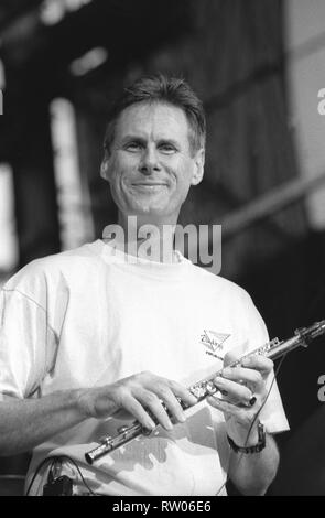 Musician Tim Weisberg is shown performing on stage during a "live ...