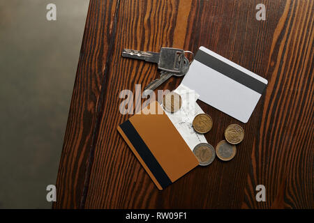 top view of credit cards, coins, cheque on wooden table Stock Photo - Alamy