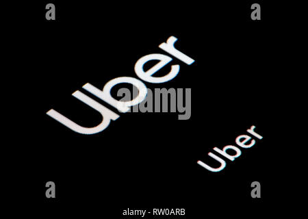 The Uber app is seen on an iPhone near a driver's vehicle in Vancouver ...