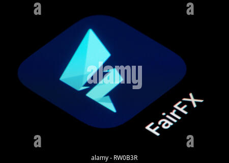 A close-up shot of the FairFX app icon, as seen on the screen of a ...