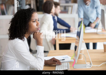 employee sitting in front of a computer screen Stock Photo - Alamy