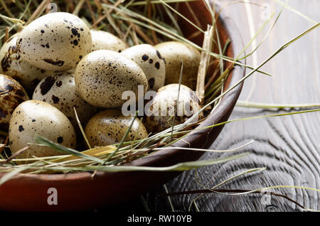 Plate with fresh quail eggs on light background Stock Photo - Alamy