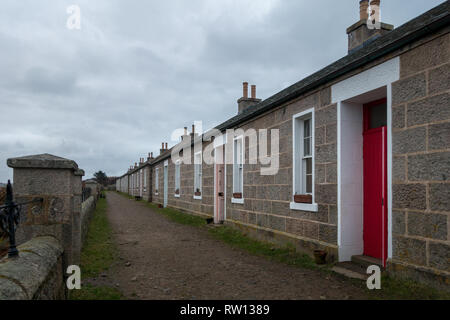 Line of houses on Erraid island with remote Royal Mail red post box ...