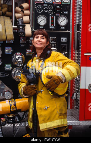 Female Hispanic Firefighter Poses in front of a Fire Truck, California ...