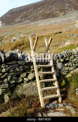 Ladder stile over a drystone wall with view to Mt Tryfan mountain and ...