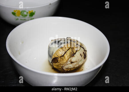 Close up of balut duck embryo on white background. Balut is a popular ...