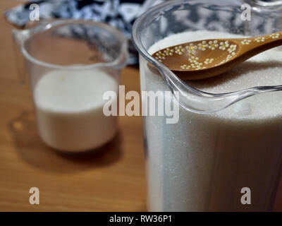 White Sugar in a Measuring Cup Stock Photo - Alamy