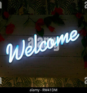 Neon night light greeting word sign text "Hello" on black background ...