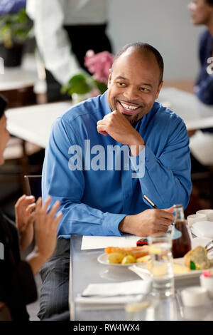 Smiling boss interviews a potential employee over lunch Stock Photo - Alamy