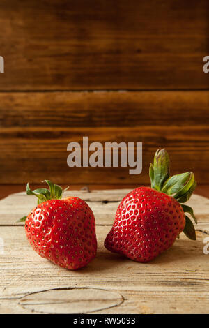 Raspberry on a blurred background of wooden planks Stock Photo - Alamy