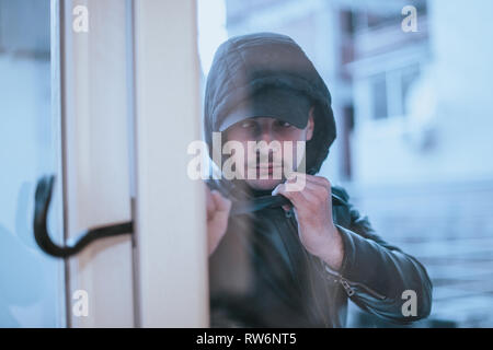 house robbery - robber trying open door with crowbar Stock Photo ...